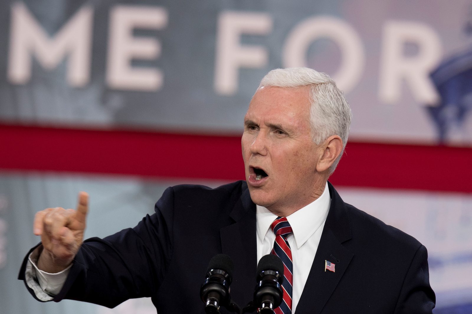 Mike Pence welcomed to town with sea of rainbow flags | PinkNews