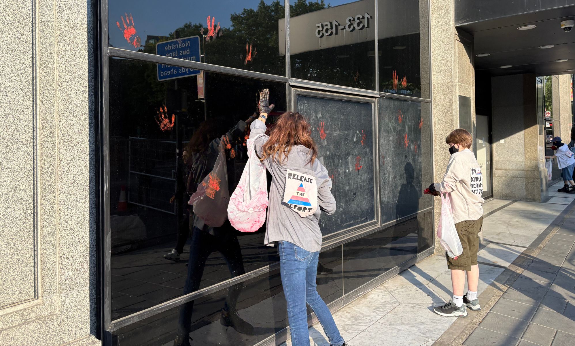 Trans youth leave 'bloody' handprints on NHS HQ in protest