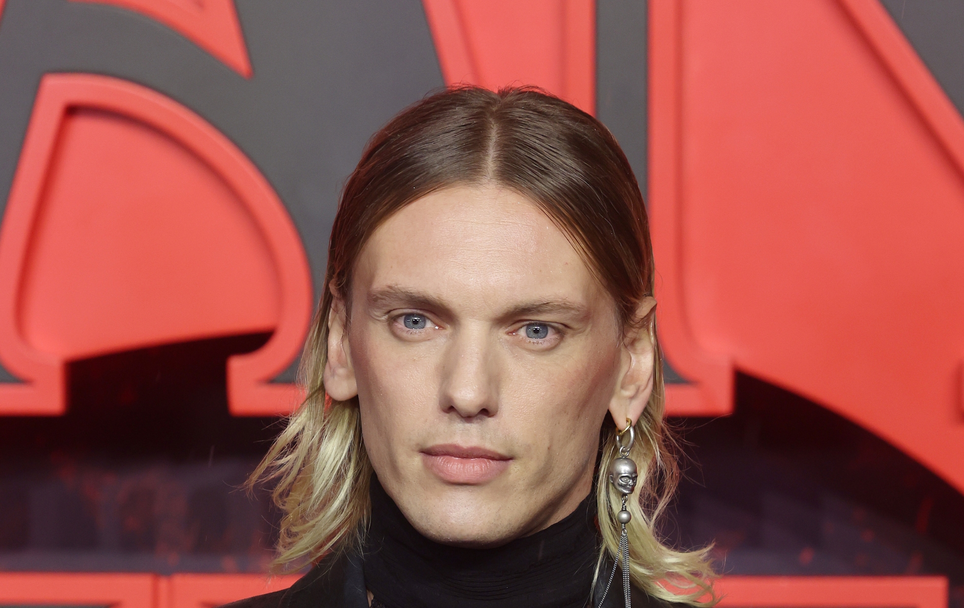 Jamie Campbell Bower wears skirt and pearls to Stranger Things premiere
